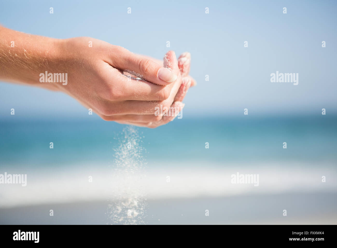 Hands holding sand on the beach Stock Photo - Alamy