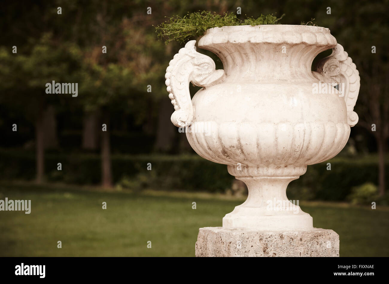 Antique marble pots in a garden. Horizontal format Stock Photo - Alamy