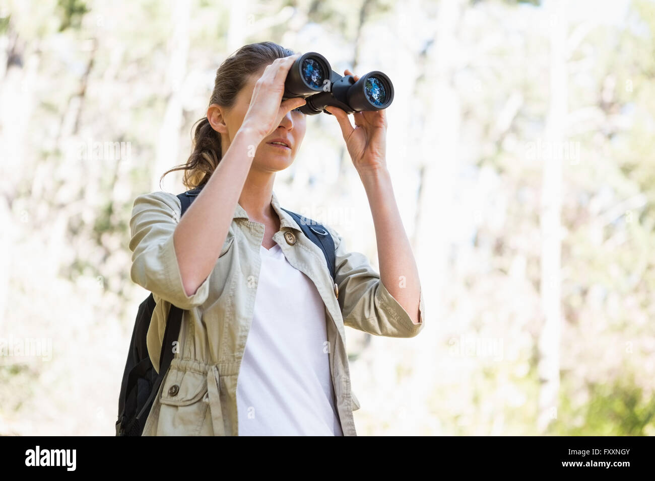 Woman using binoculars Stock Photo - Alamy