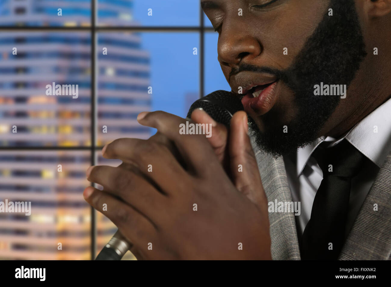Afro singer with eyes closed Stock Photo - Alamy