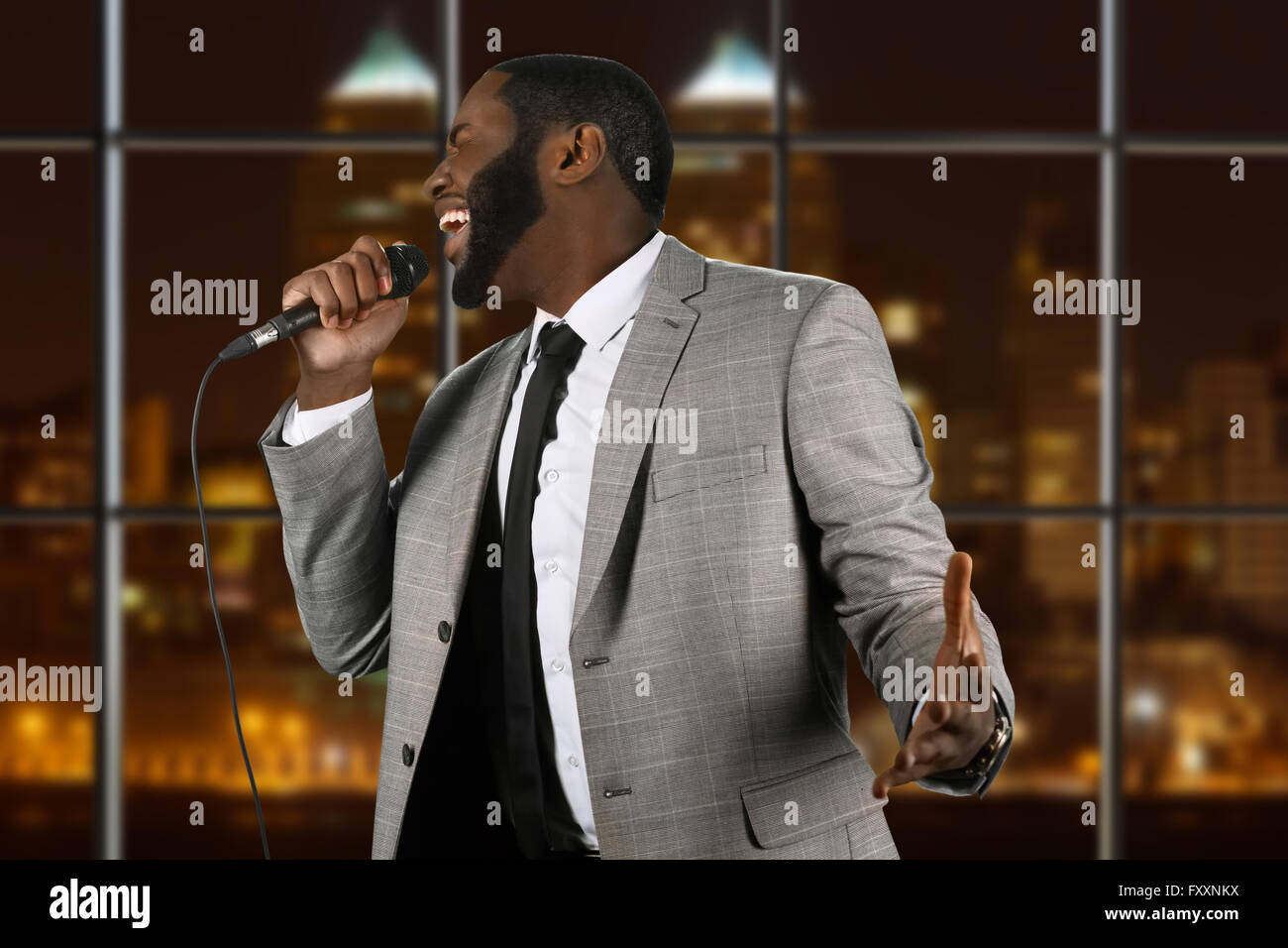 Expressive black singer with microphone Stock Photo - Alamy