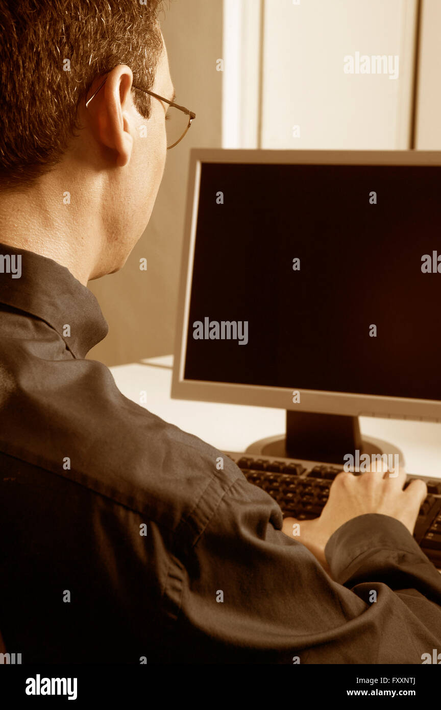 Business man and computer in sepia tone. Vertical format Stock Photo ...