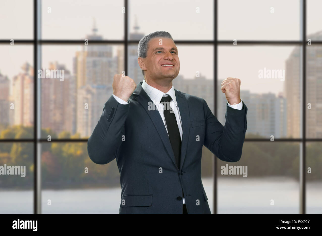 Mature businessman smiling happily Stock Photo - Alamy