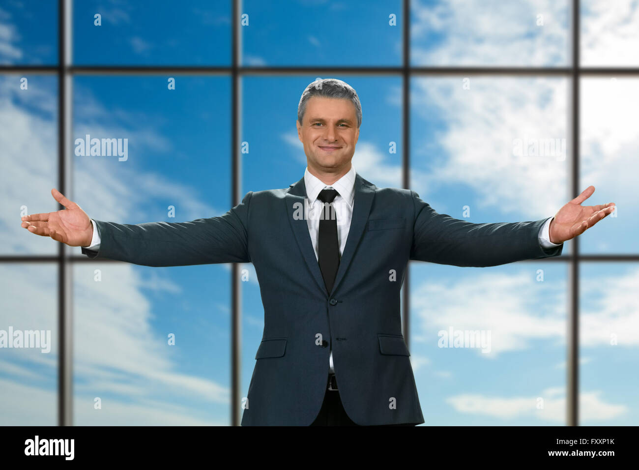 Adult businessman's welcoming gesture Stock Photo - Alamy