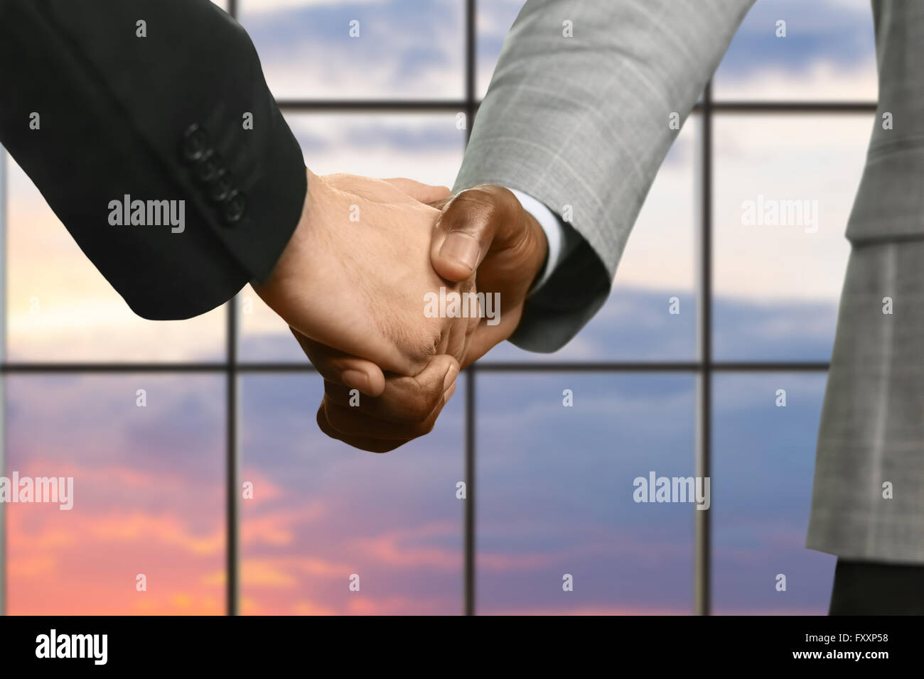 Businessmen in suits shake hands Stock Photo - Alamy
