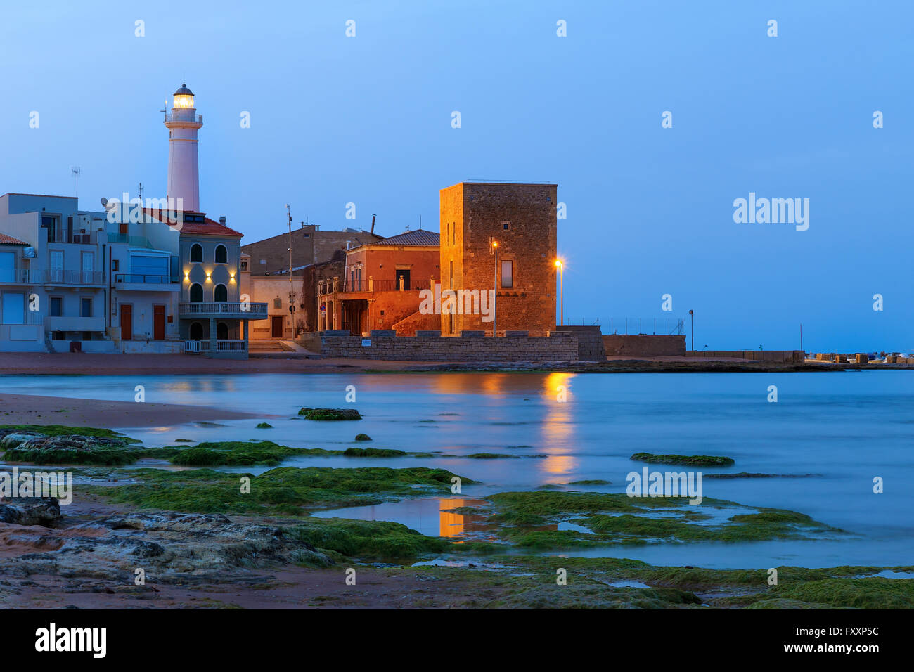 Dawn at Punta Secca Beach with the lighthouse and the watchtower,Torre Scalambri in Santa Croce ...