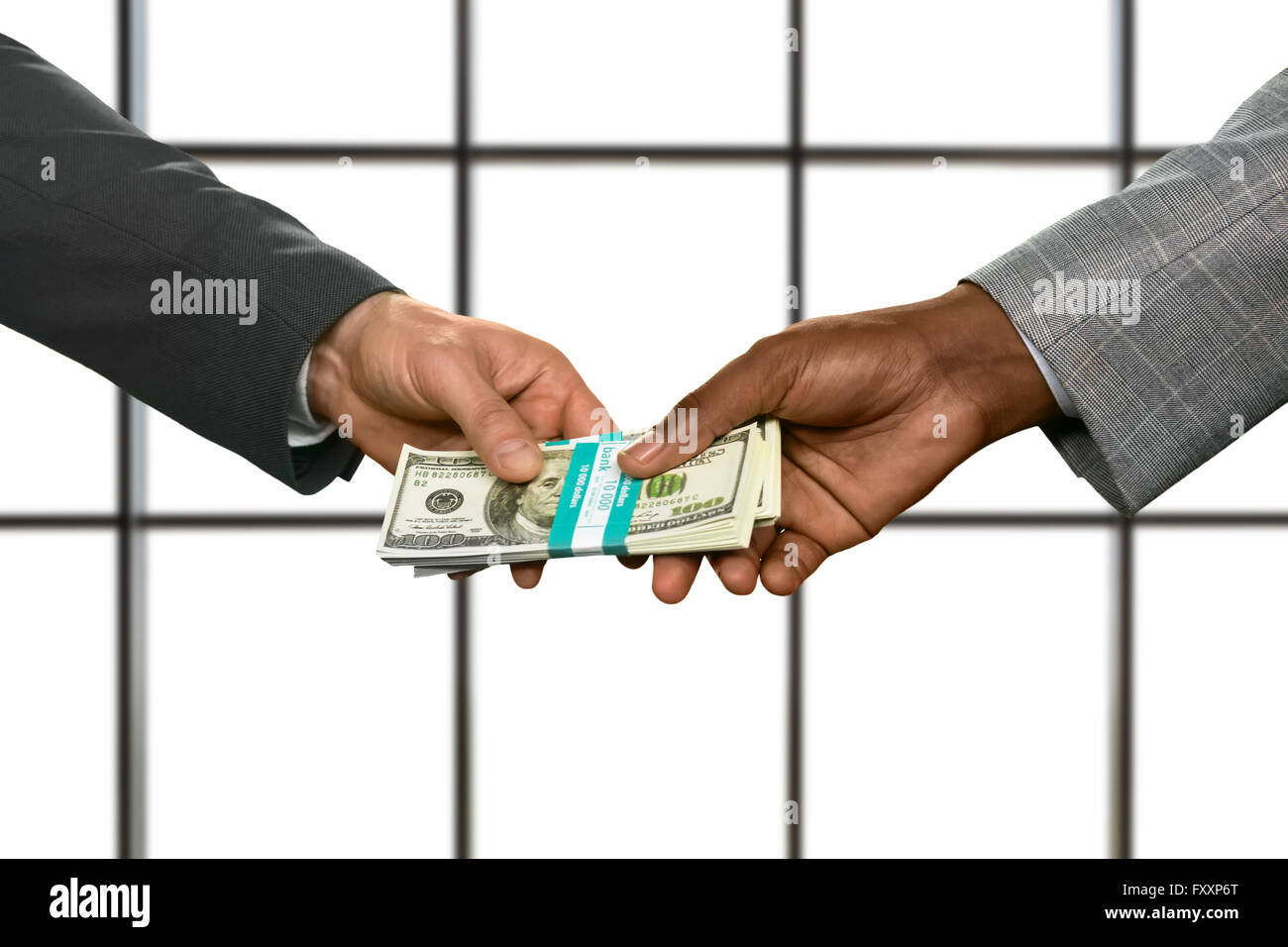 Businessmen's hands passing money bundle Stock Photo - Alamy