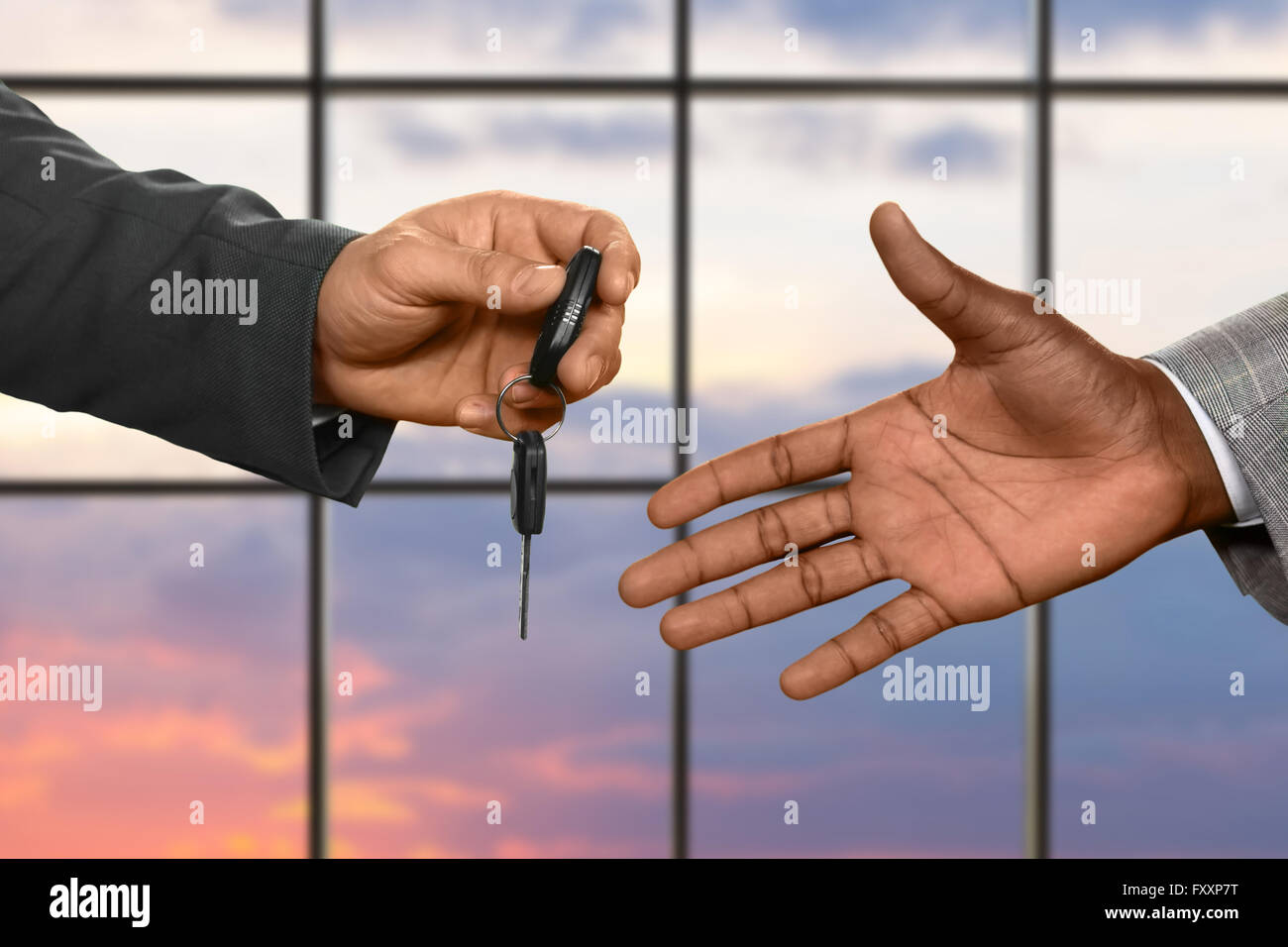 Man's hand passing car key Stock Photo - Alamy