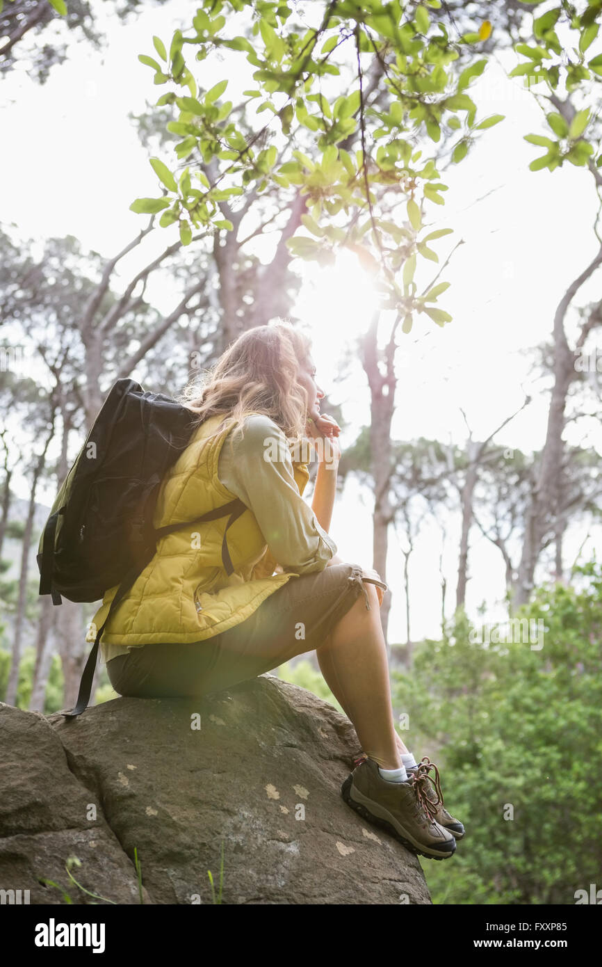 Woman sitting on a stone Stock Photo - Alamy