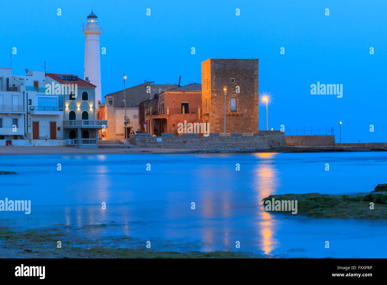 Dusk at Punta Secca Beach with the lighthouse and the watchtower,Torre ...
