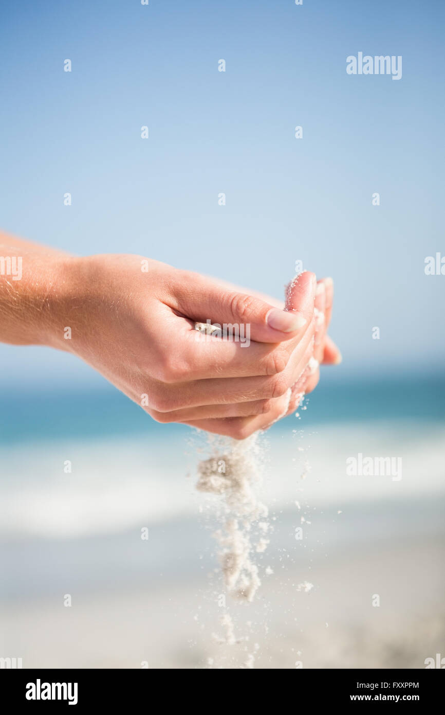 Hands holding sand on the beach Stock Photo - Alamy
