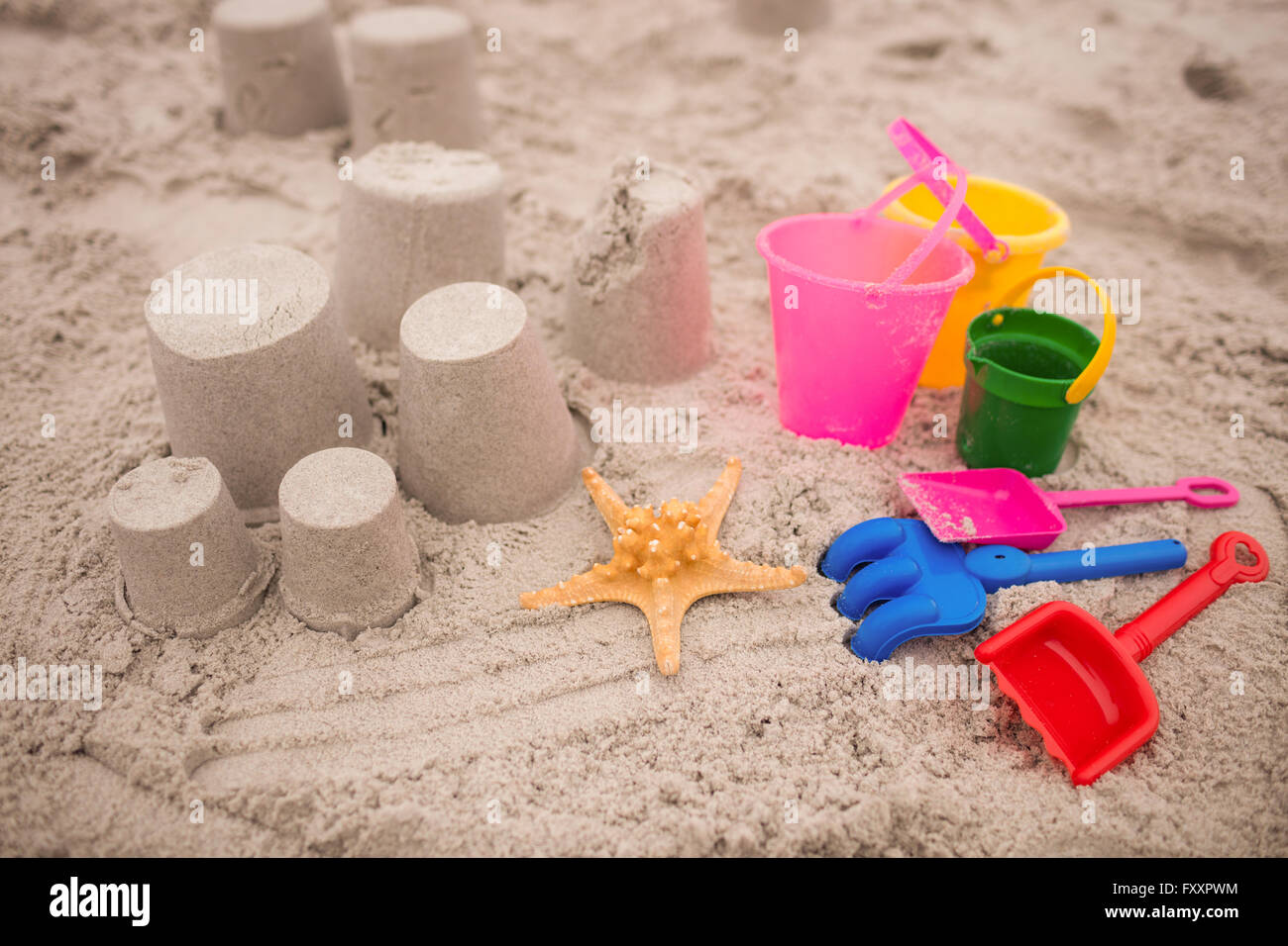 Sandcastle with bucket and spade at beach Stock Photo - Alamy