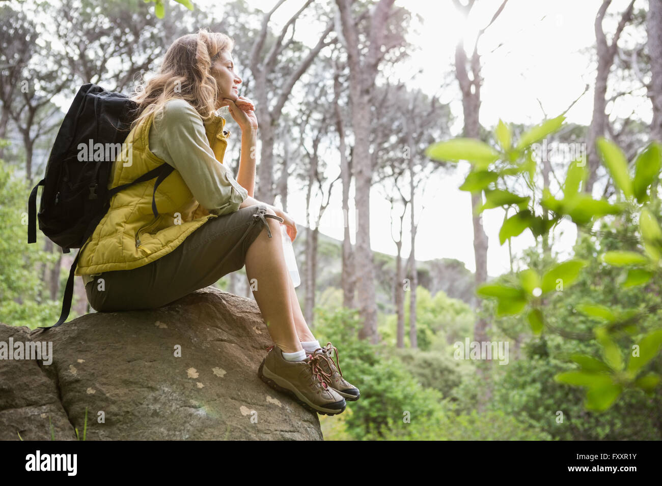 Woman sitting on a stone Stock Photo - Alamy