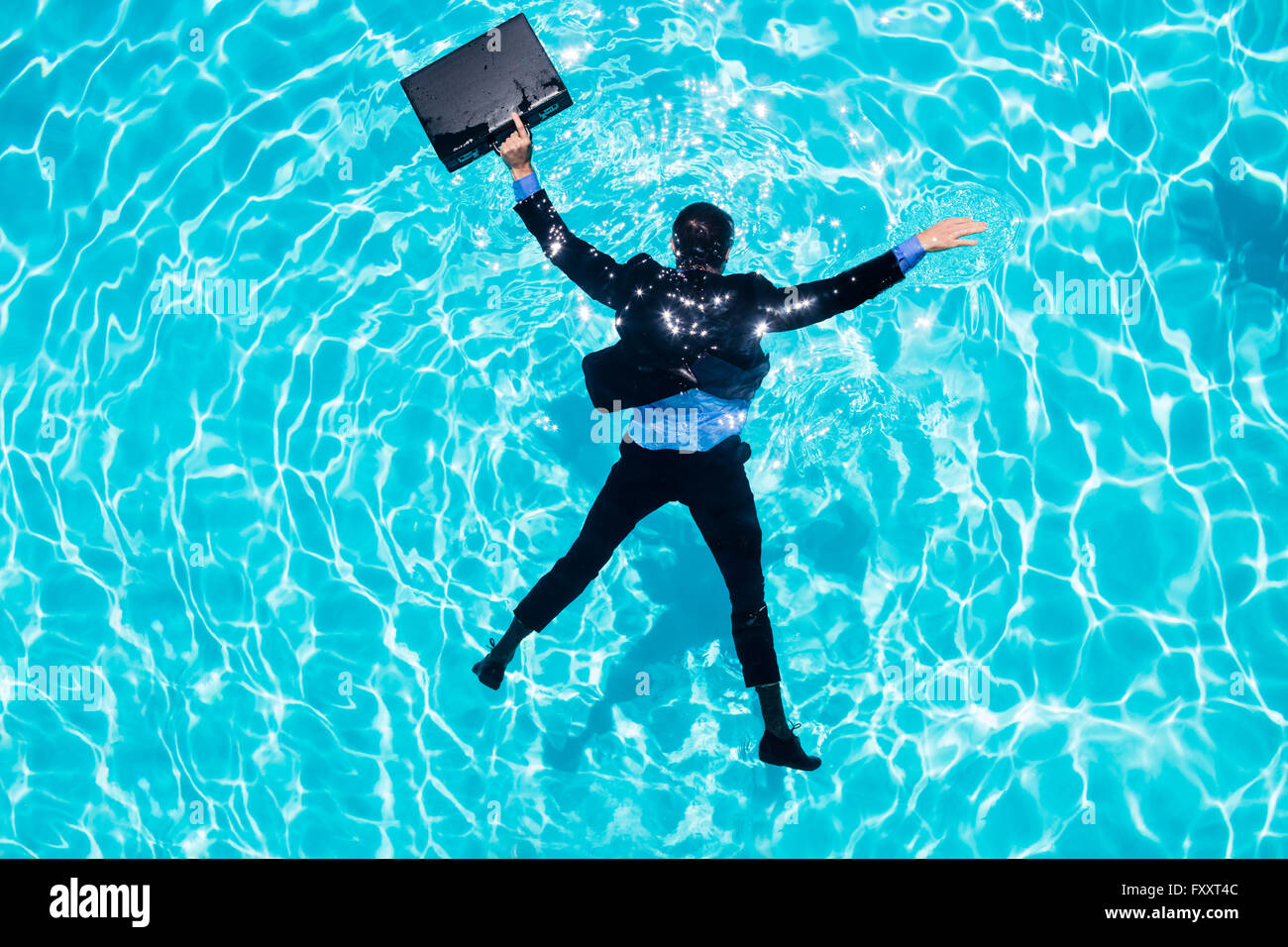 Dressed businessman in swimming pool Stock Photo - Alamy
