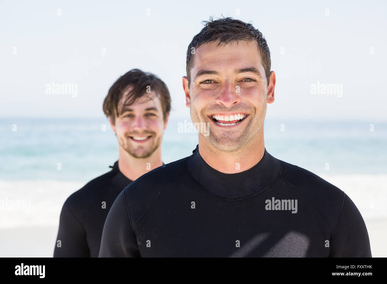 Handsome men wearing wetsuits hi-res stock photography and images - Alamy