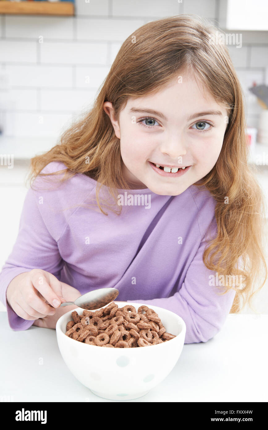 Girl Eating Bowl Of Sugary Breakfast Cereal In Kitchen Stock Photo - Alamy