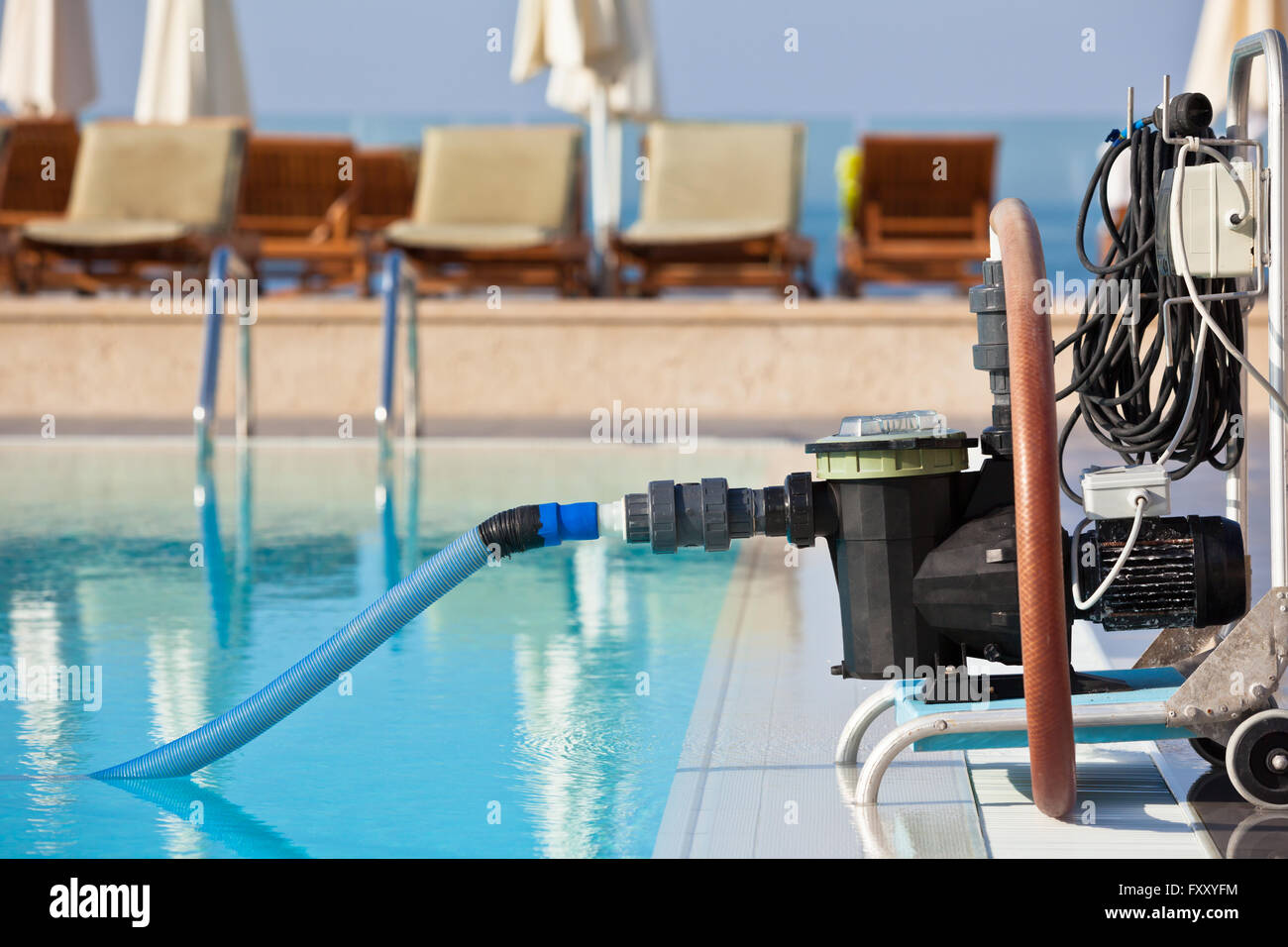 Cleaning pump working with a swimming pool. Horizontal shot Stock Photo ...