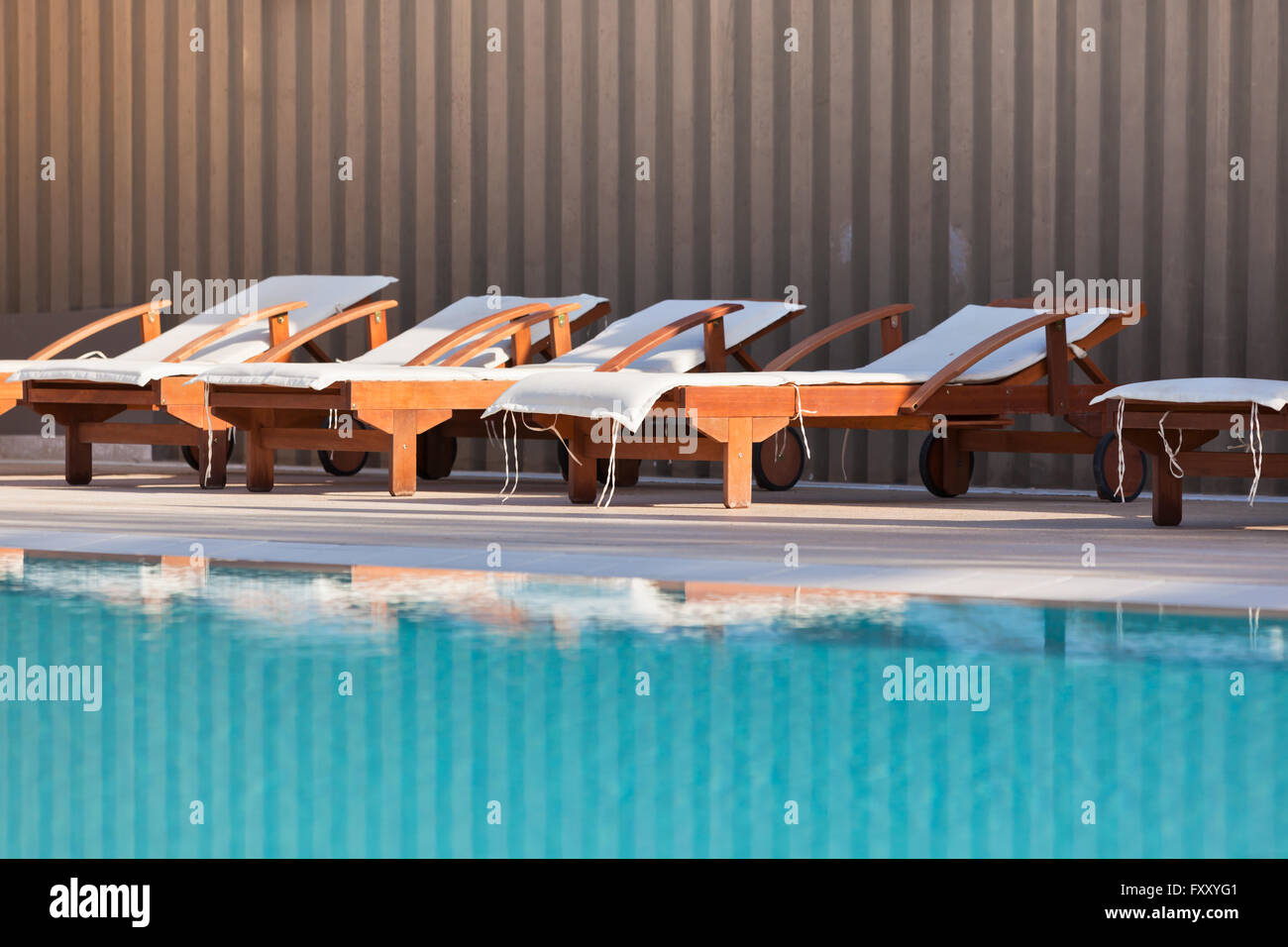 Hotel Poolside Chairs near a swimming pool. Summer shot Stock Photo - Alamy