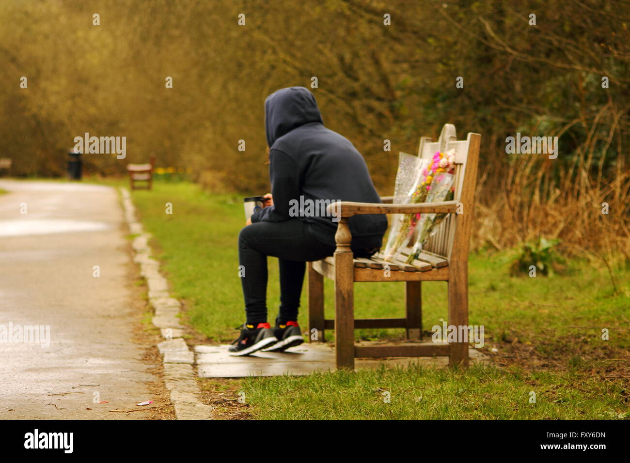 hooded girl on park bench Stock Photo - Alamy