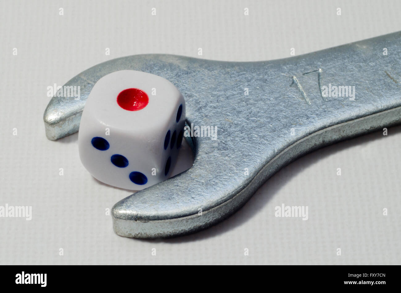 A Studio Photograph of a Spanner with a Die Showing the Number One ...