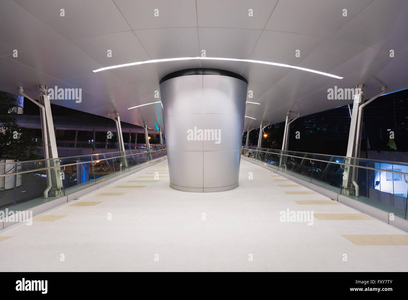Public indoor walkway with big pillar on center during night time in ...