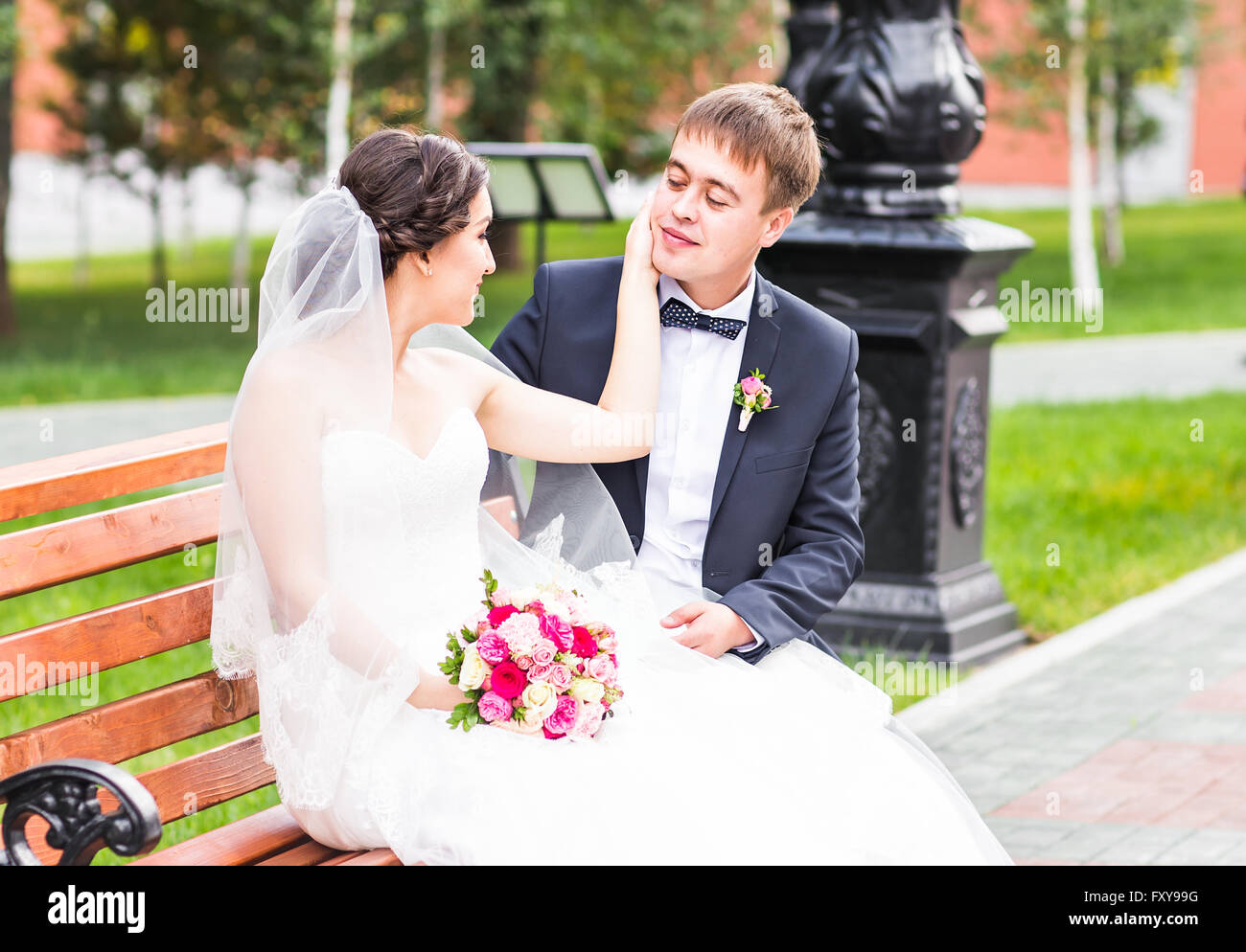 Beautiful bride and groom embracing on their wedding day outdoors Stock ...