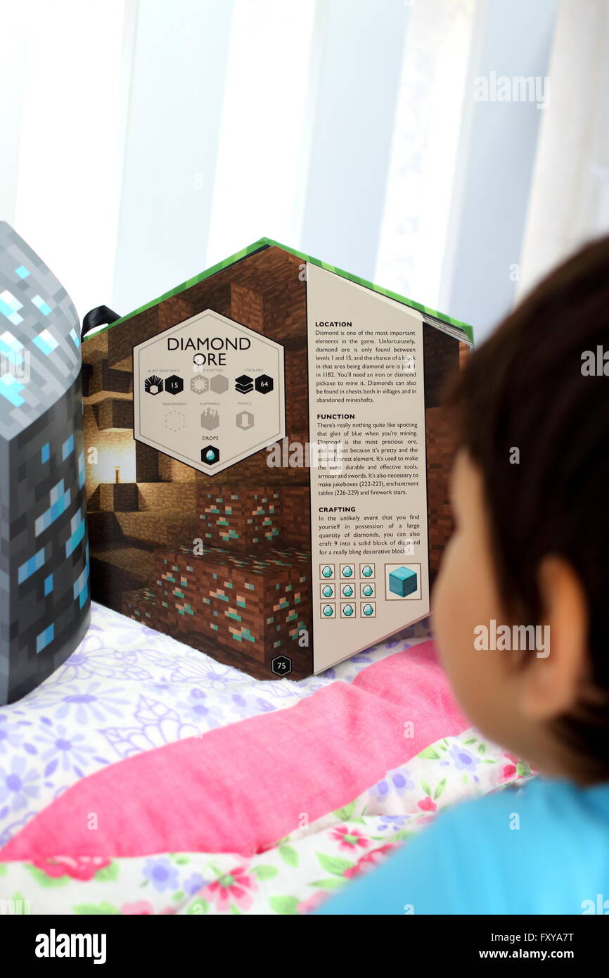 Young boy reading Minecraft book Stock Photo - Alamy