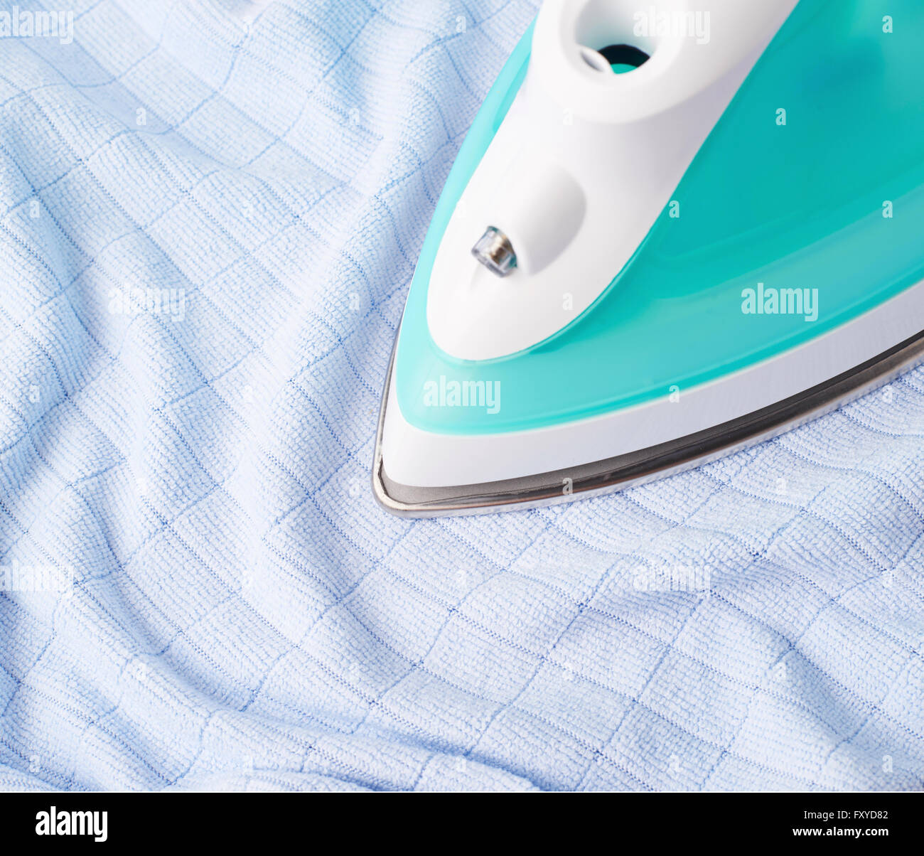 Iron with blue cloth composition Stock Photo - Alamy