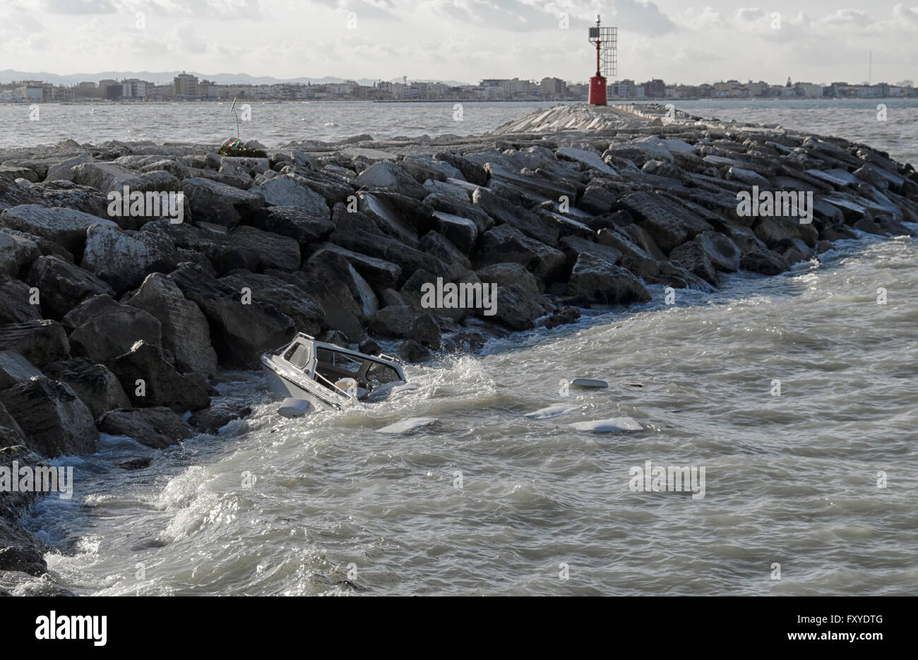 Sinking small boat in front of the port of Rimini Stock Photo - Alamy