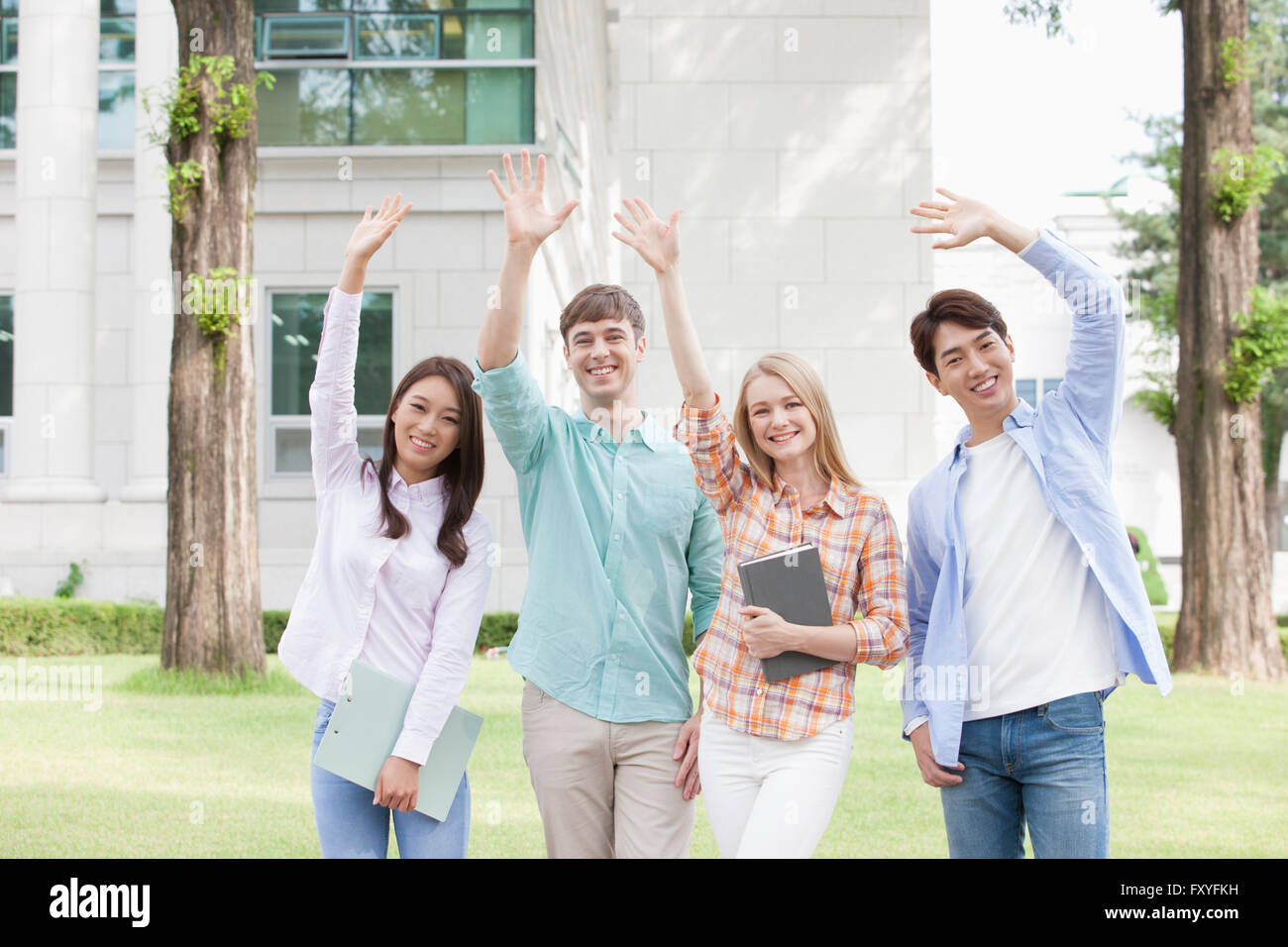 International students with domestic students in college waving their ...