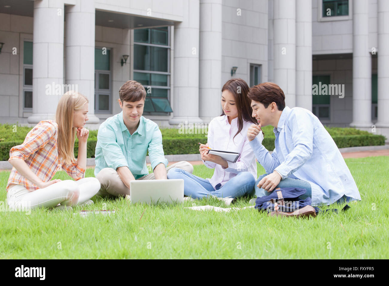 Domestic students and internationals students in college seated on a ...