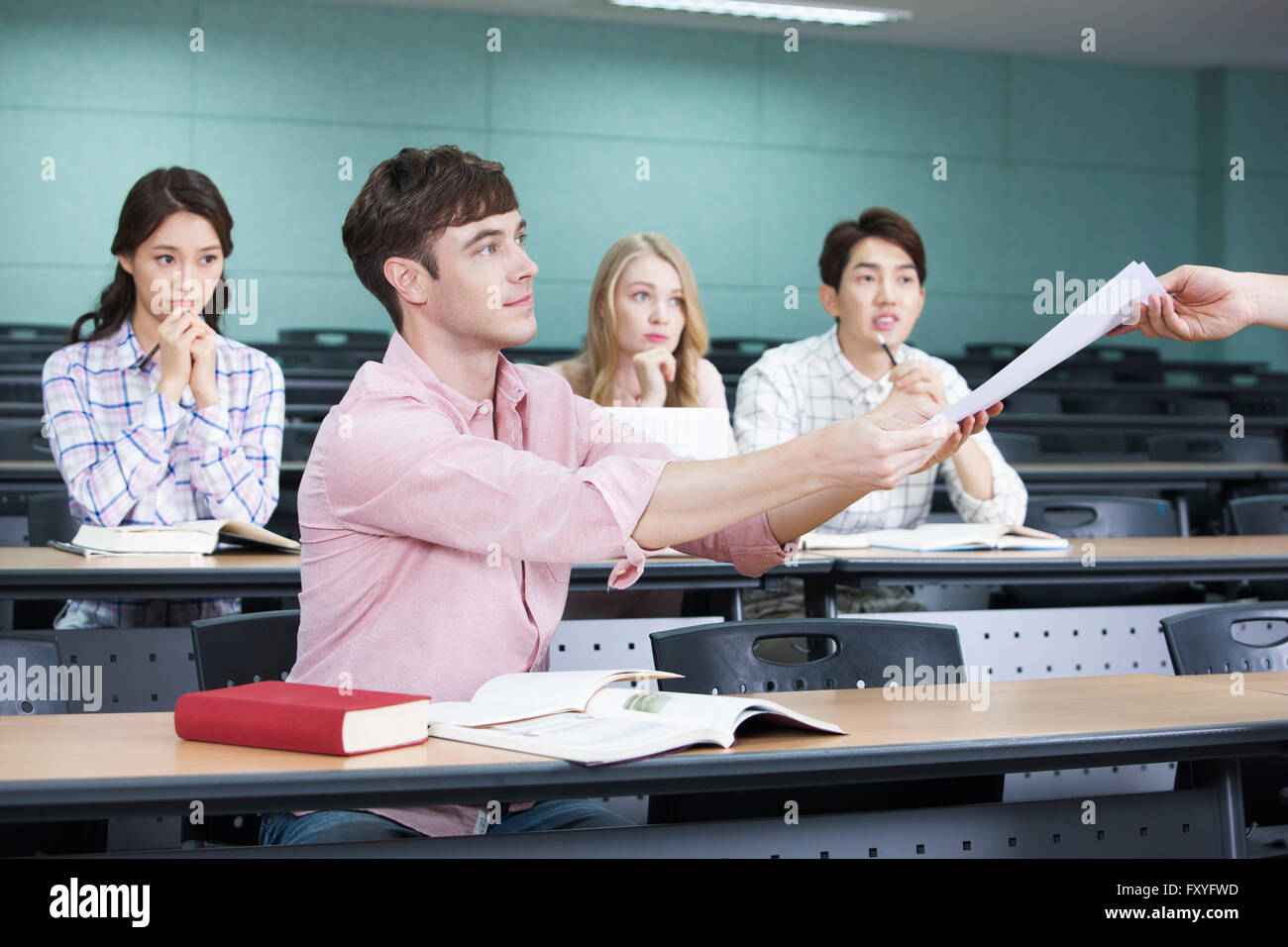 International student being handed with a paper from a person and other ...