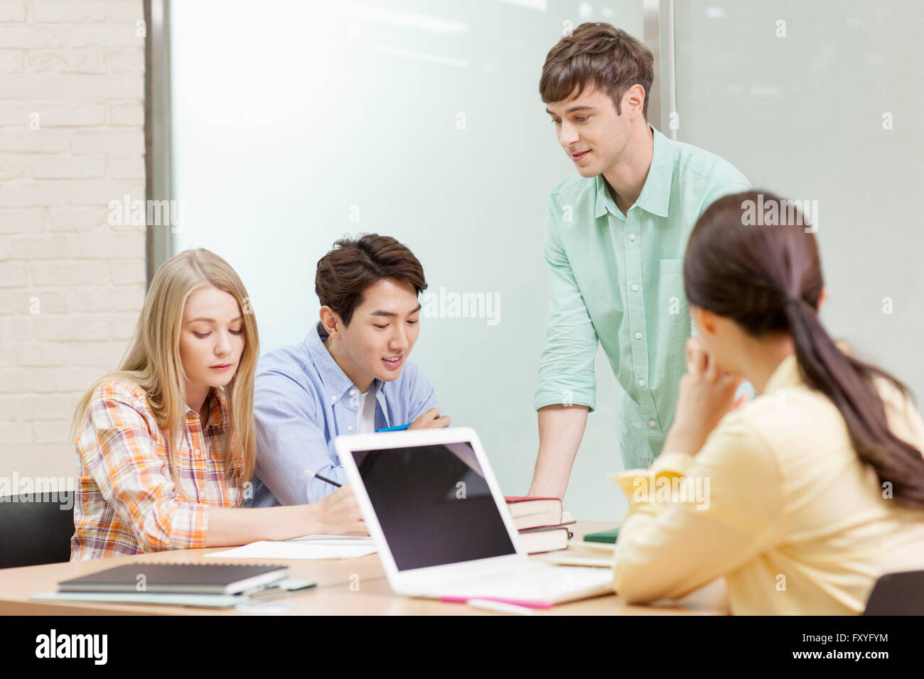 International students in college studying together in classroom and ...