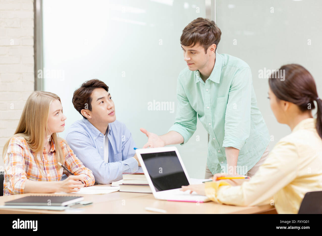International students in college studying together in classroom and ...