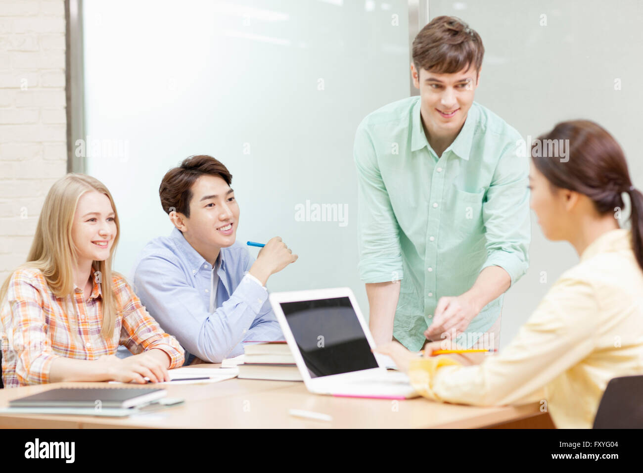 International students in college studying together in classroom and ...