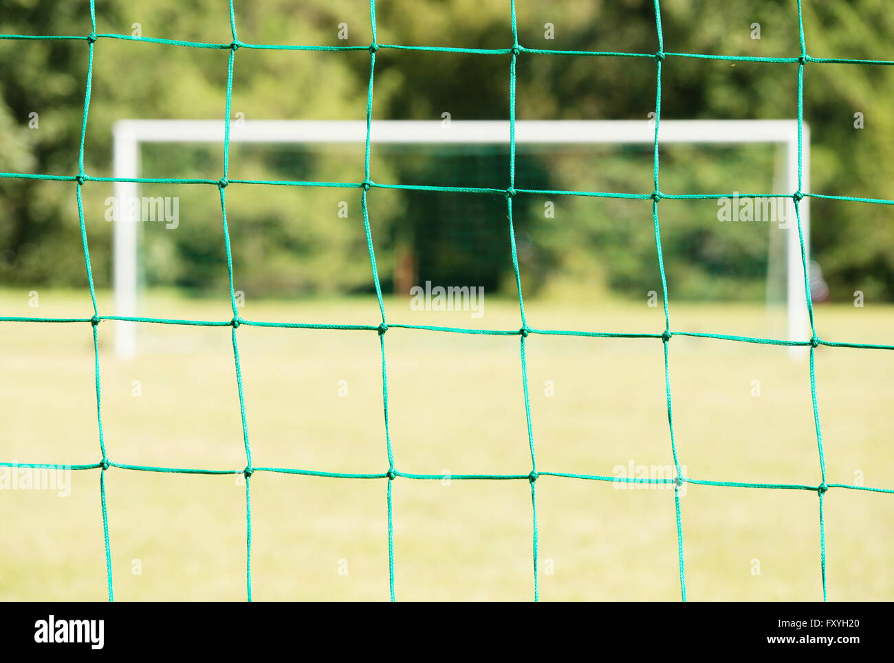 Empty soccer field seen through the net of the goal, Sweden Stock Photo ...