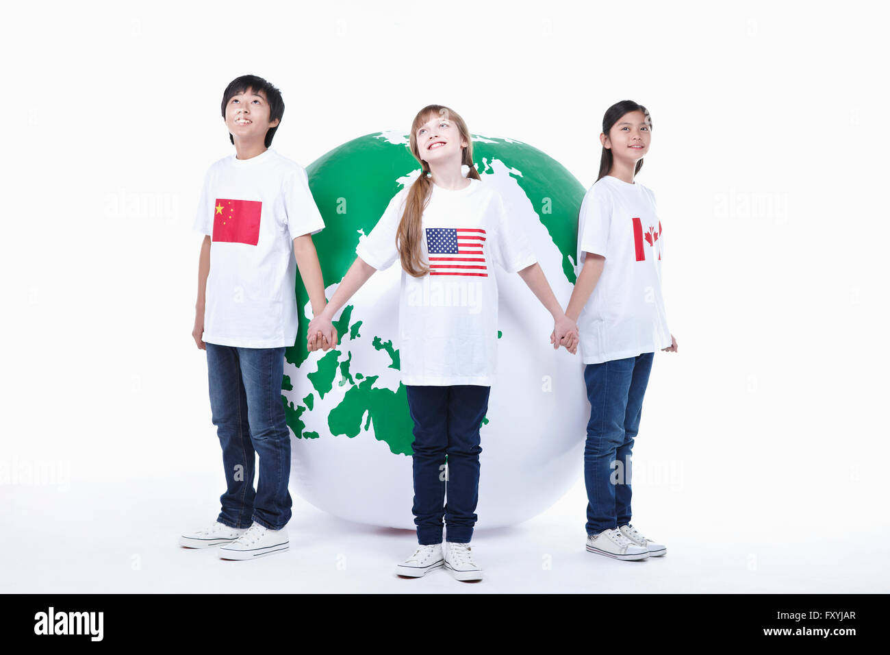 Three middle school students from different countries standing and ...