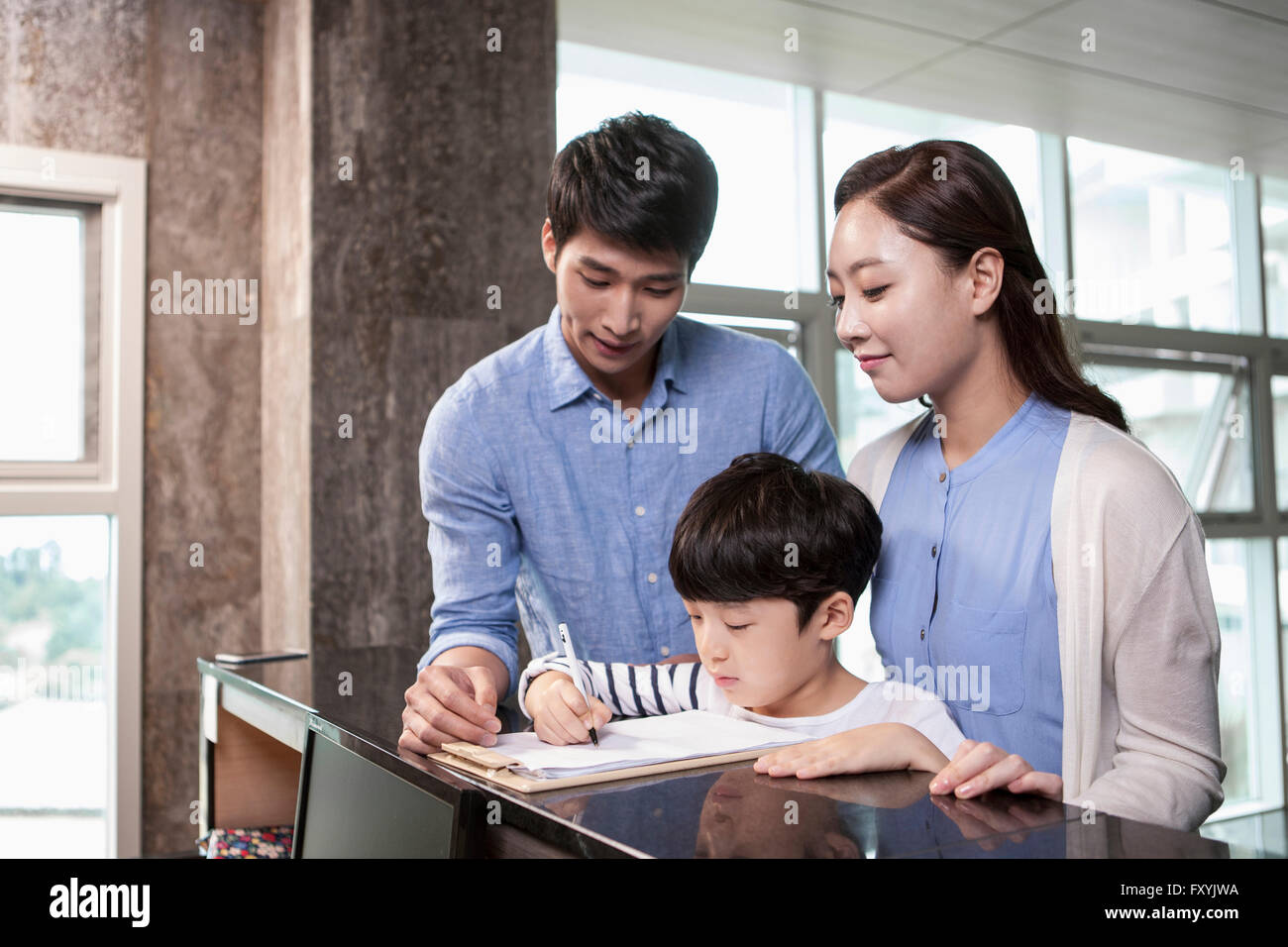 Family checking in hi-res stock photography and images - Alamy