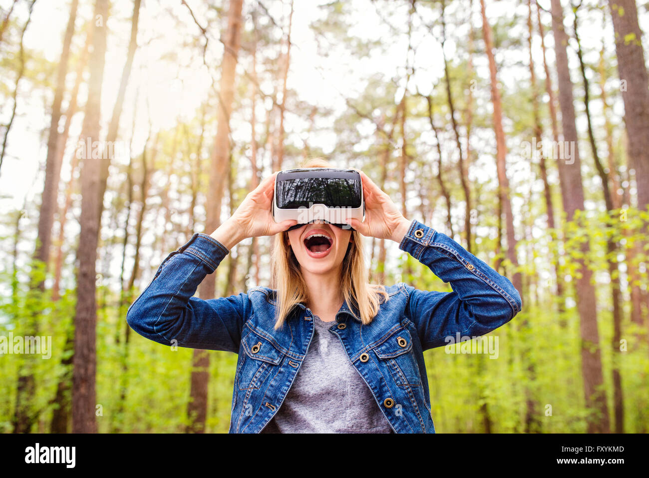 Woman wearing virtual reality goggles outside in spring nature Stock ...