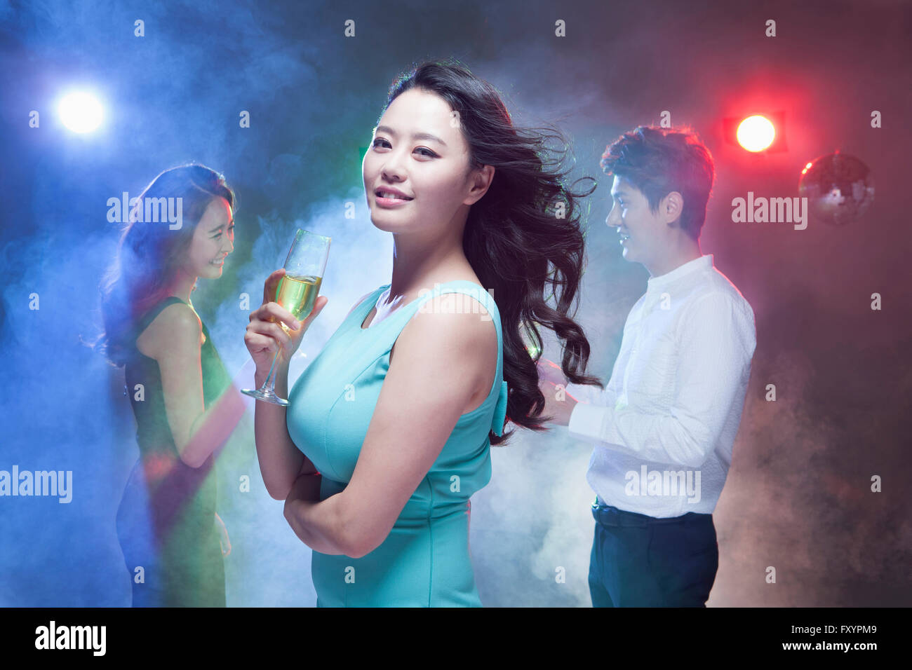 Portrait of young smiling people at nightclub Stock Photo - Alamy