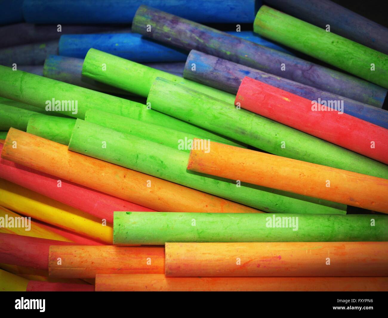 Colored chalk on a blackboard background Stock Photo - Alamy