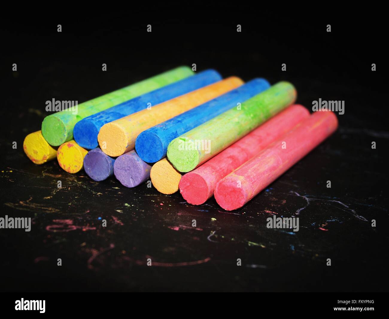 Colored chalk on a blackboard background Stock Photo - Alamy