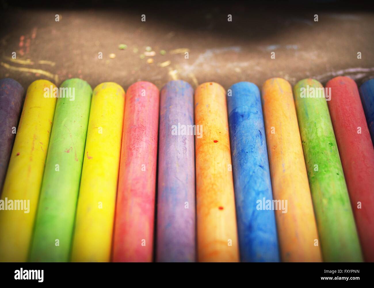 Colored chalk on a blackboard background Stock Photo - Alamy