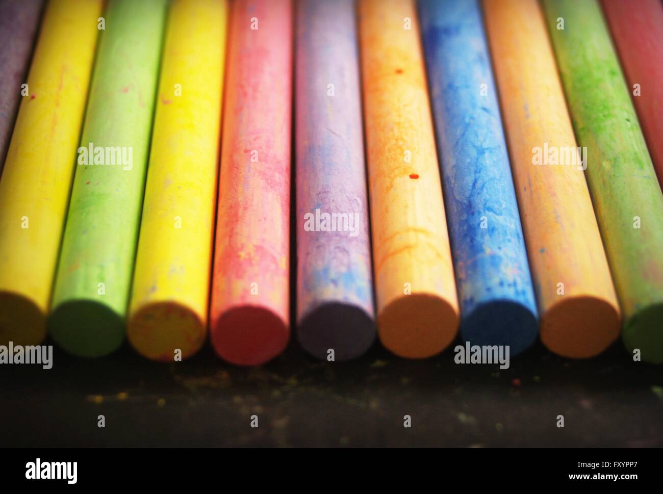 Colored chalk on a blackboard background Stock Photo - Alamy