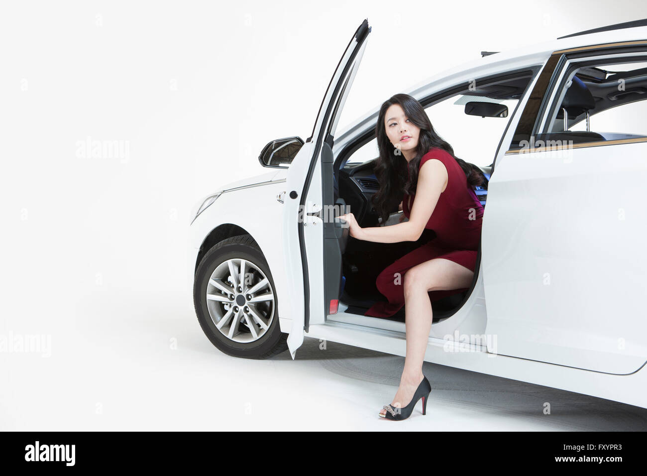 Young woman getting off a fancy car Stock Photo - Alamy