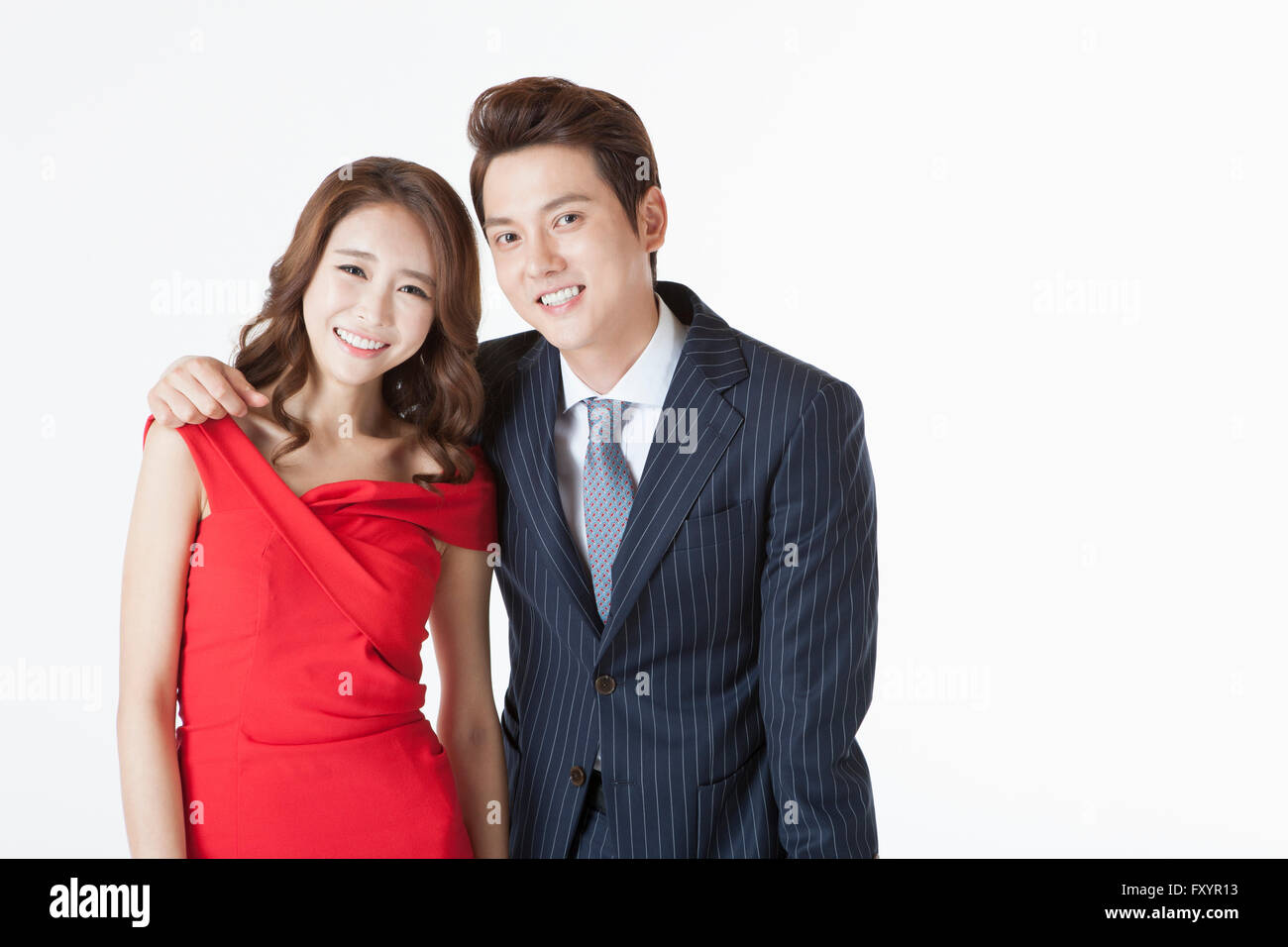 Portrait of young smiling couple staring at front Stock Photo - Alamy