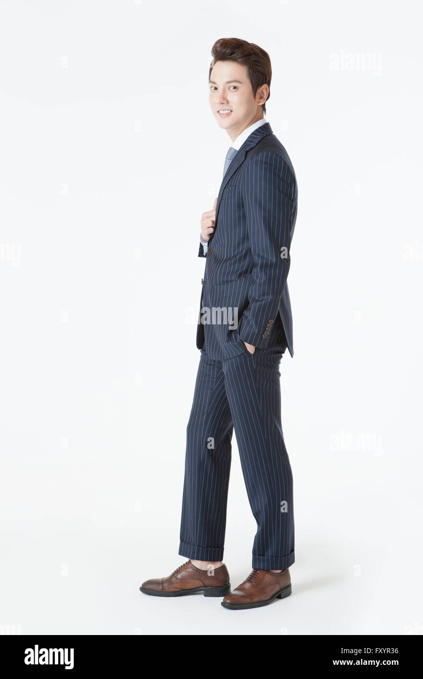 Side view of young smiling man in suit staring at front Stock Photo - Alamy