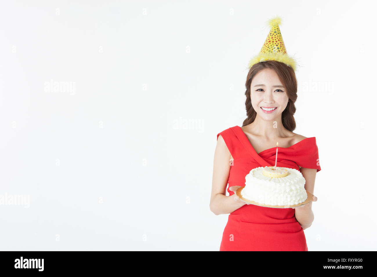 Portrait of young smiling woman holding a cake staring at front Stock ...