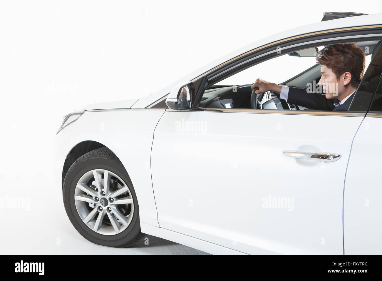 Side view portrait of young man in suit holding handle in a car Stock ...