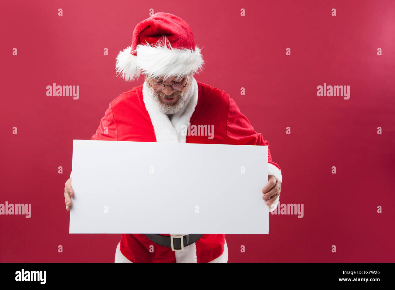 Portrait of Santa Claus holding a paper looking down Stock Photo - Alamy